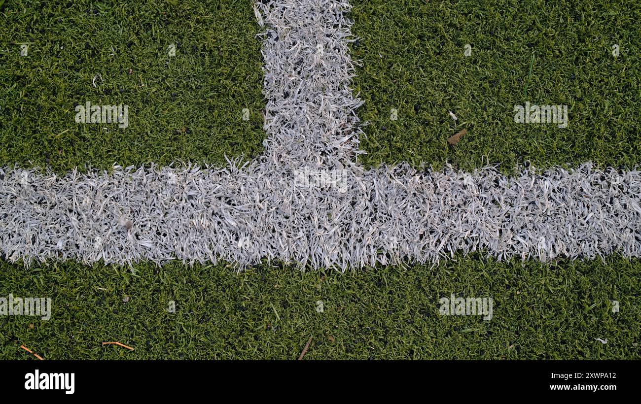 Intersection of white boundary lines on green artificial turf. Soccer ...