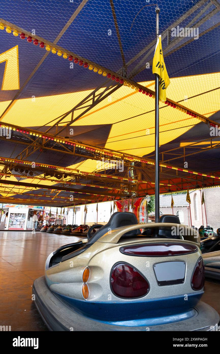Empty bumper car at a fairground with a pantograph and a metal ...