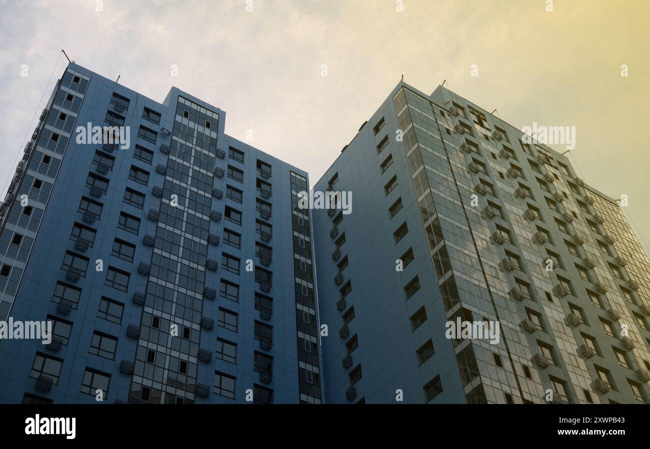 Residential high-rise buildings at sunset. Modern urban living, real ...