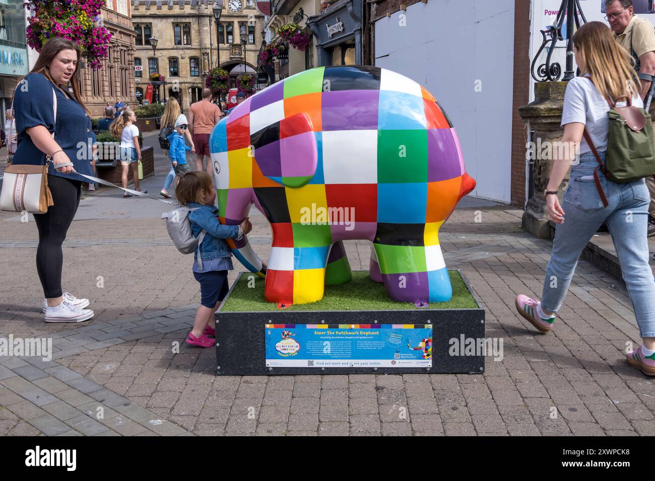 Child hugging elmer the patchwork elephant hi-res stock photography and ...