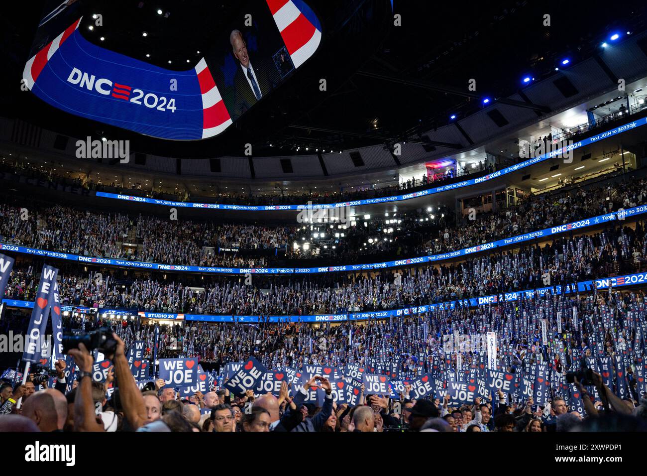 Chicago, United States. 20th Aug, 2024. The crowd holds up signs that ...