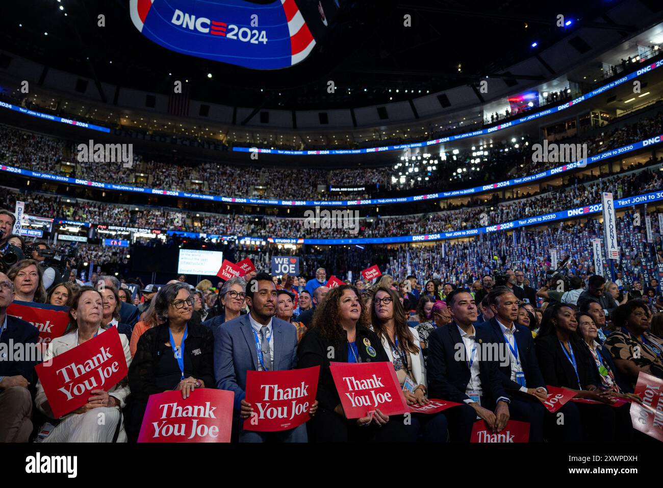 Chicago, United States. 20th Aug, 2024. The crowd holds up signs that ...