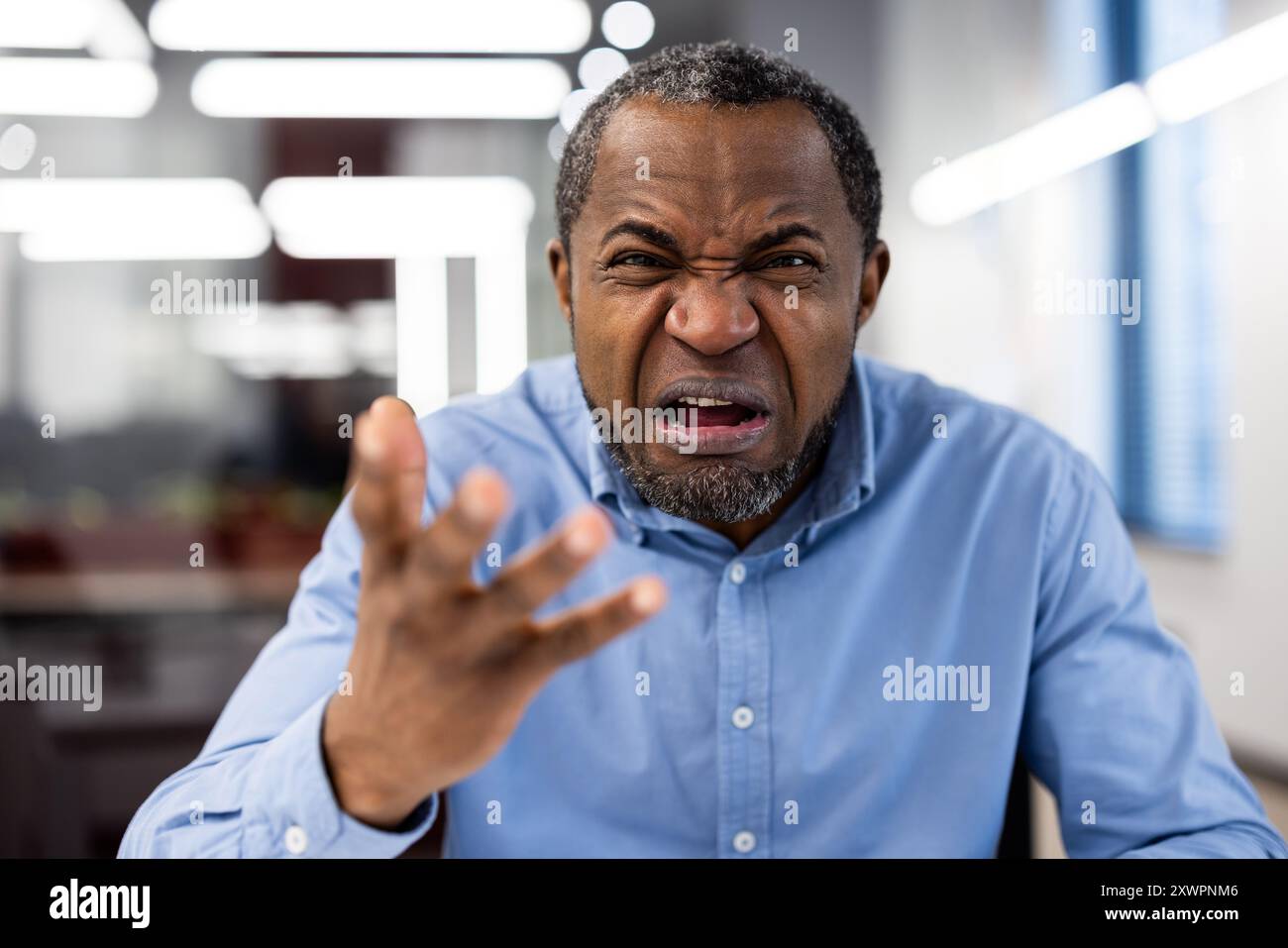 African American businessman visibly frustrated at office, expressing ...
