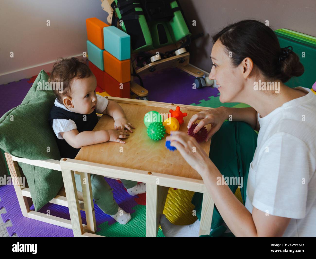 Occupational therapist performing a session of sensory integration ...