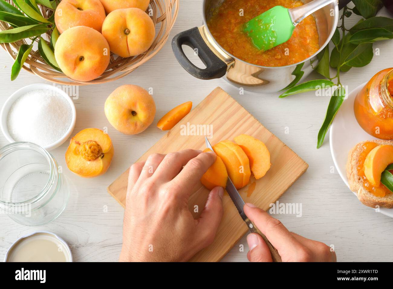 Person cutting peach pieces hi-res stock photography and images - Alamy
