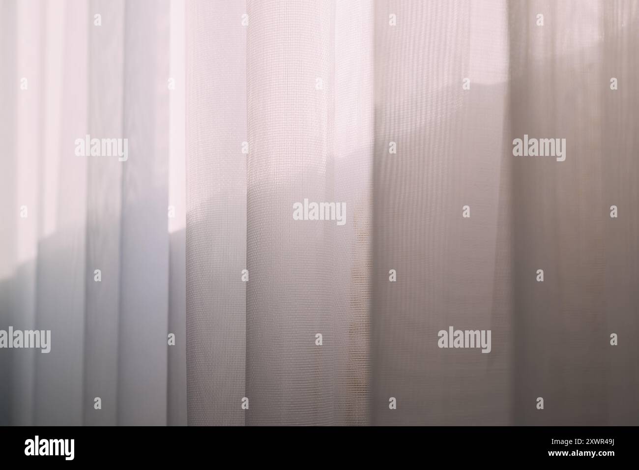 Bright light coming from the living room window through white curtains ...