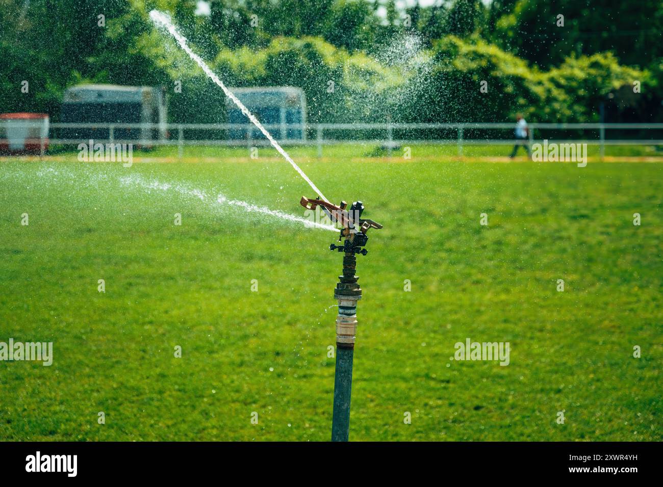 Water irrigation impact sprinkler in operation in field, selective focus Stock Photo - Alamy