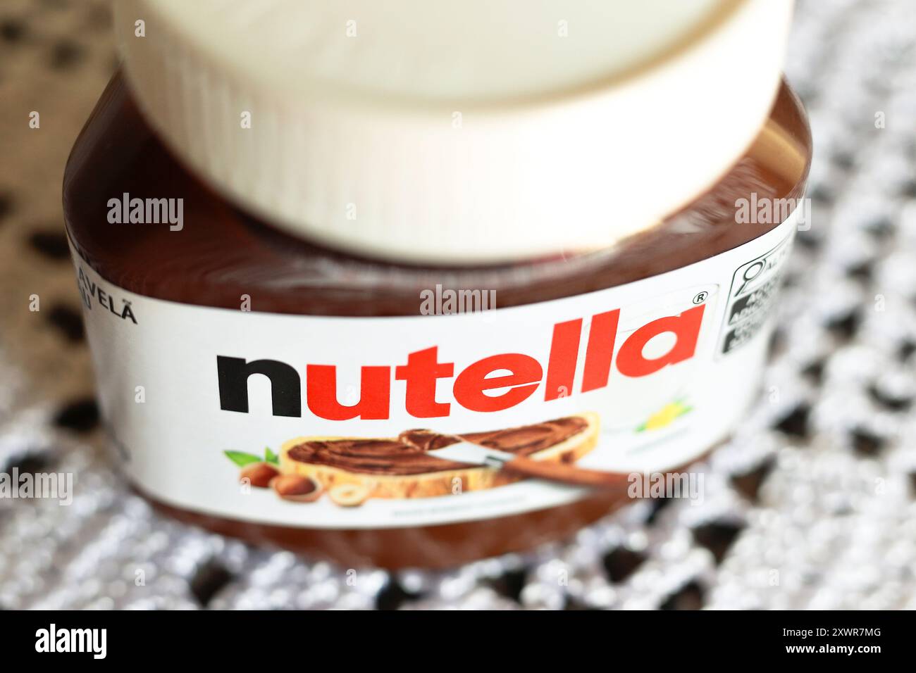 in this photo illustration, a Nutella logo seen displayed on a bottle ...