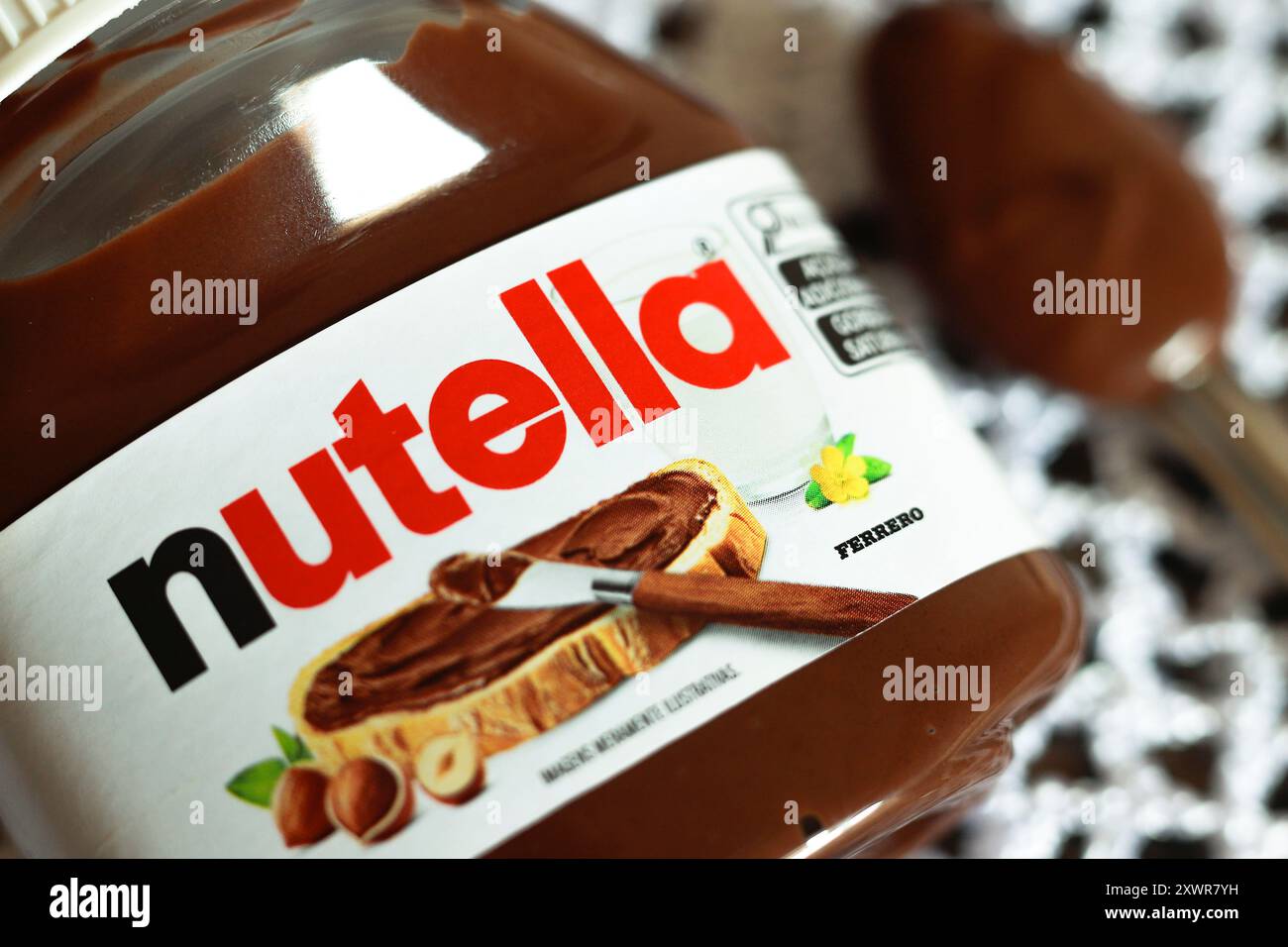 in this photo illustration, a Nutella logo seen displayed on a bottle ...