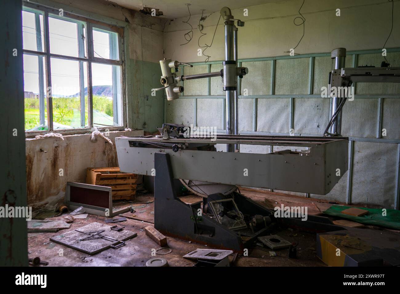 Interior of an abandoned destroyed hospital. X-ray machine Stock Photo ...