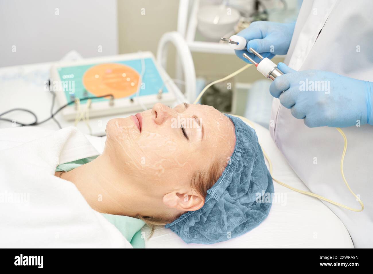 Dermatology anti age treatment. Microcurrent medicine procedure. Woman ...