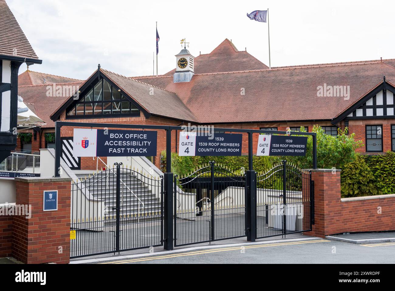 Entrance to a modern sports facility with clear signage for ...