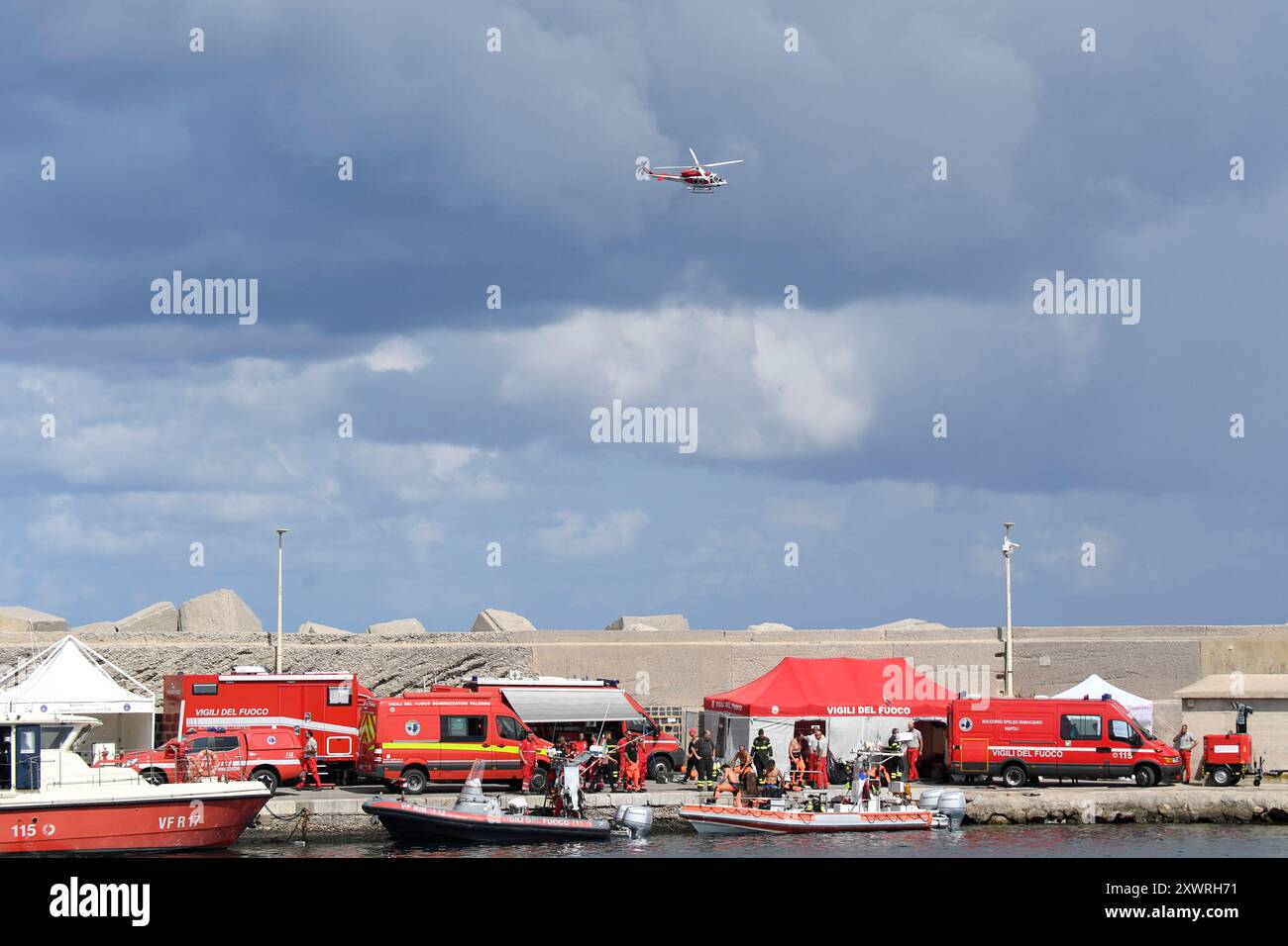 An Italian Firefighters helicopter flies over the harbor of Porticello ...
