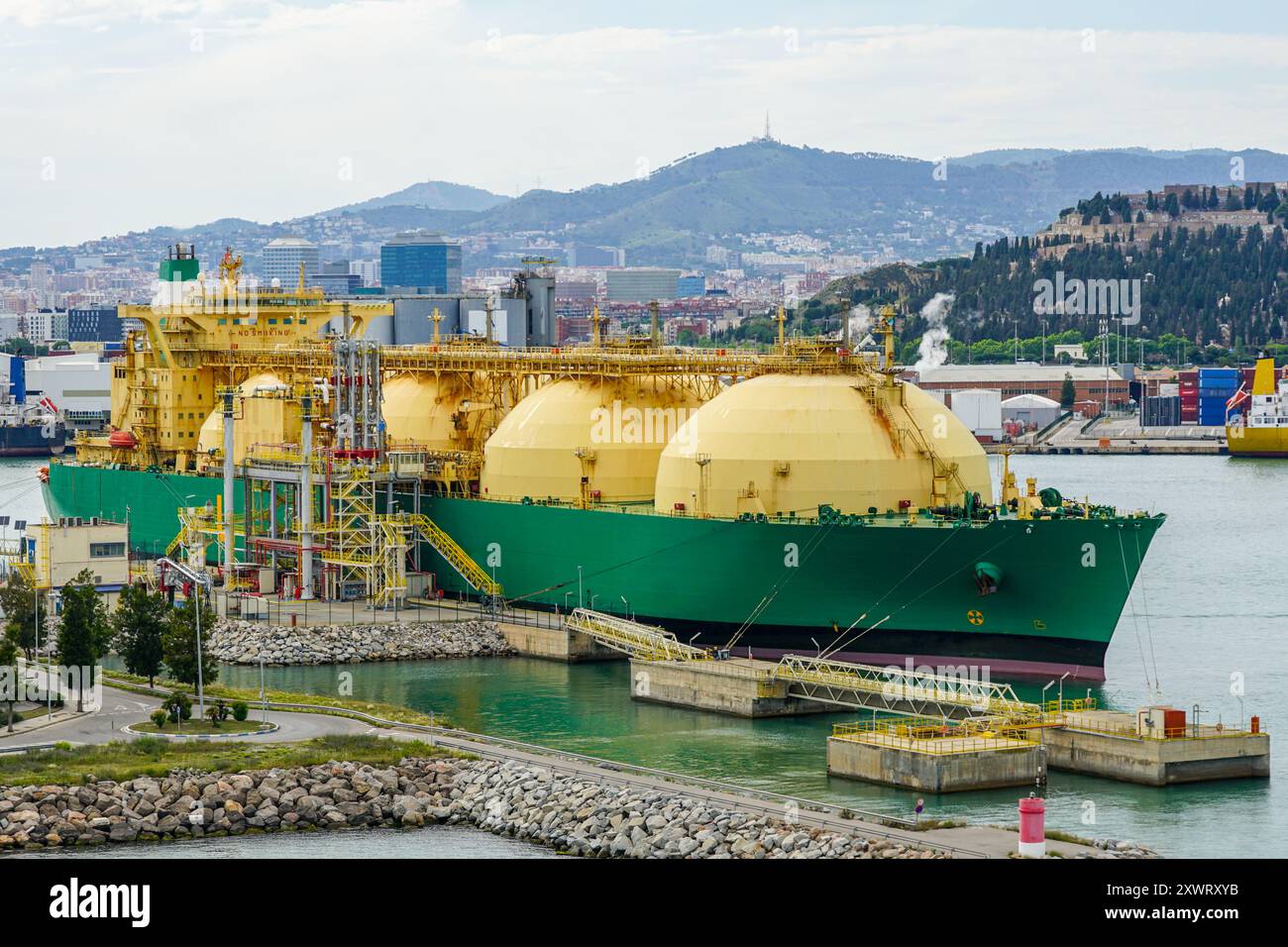 Large LNG tanker unloading at Barcelona port gas terminal, liquefied natural gas tanker ...