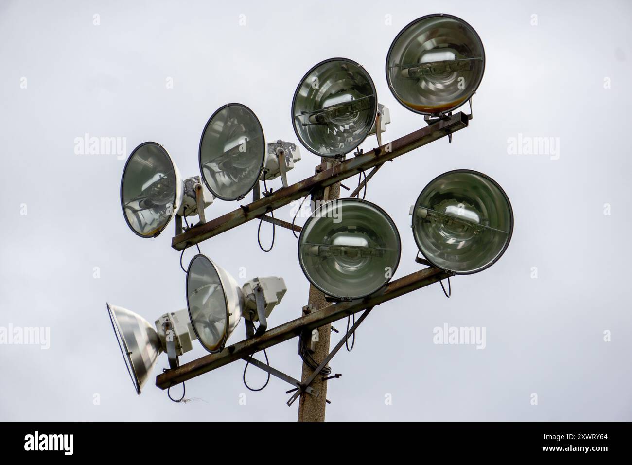 Outdoor stadium flood lights and stand against a white sky background ...