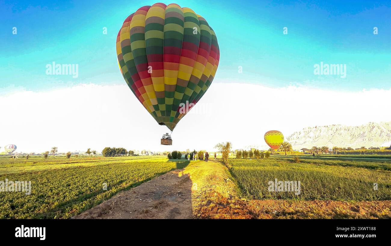 A breathtaking sight of a hot air balloon gently descending into the ...