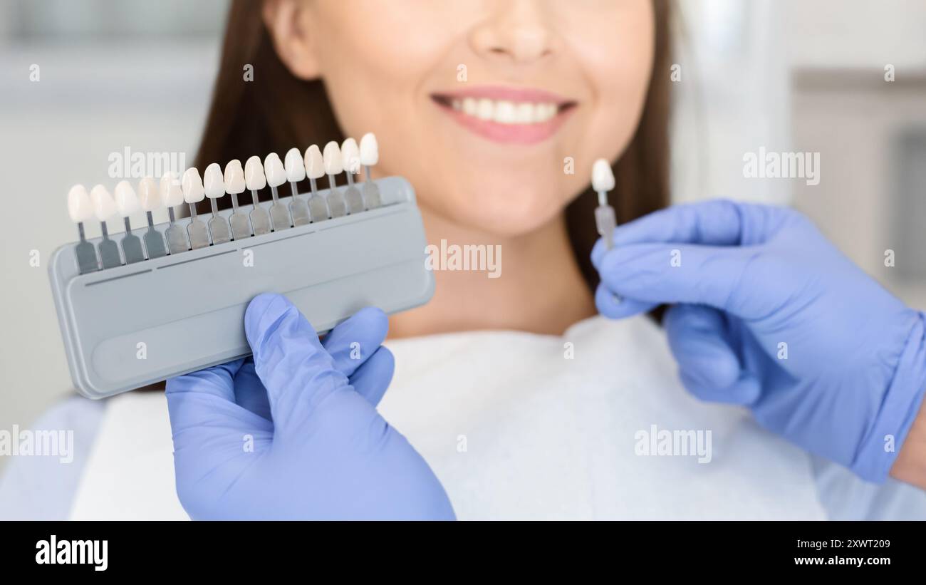 Doctor applying sample from tooth scale to smiling patient teeth Stock ...