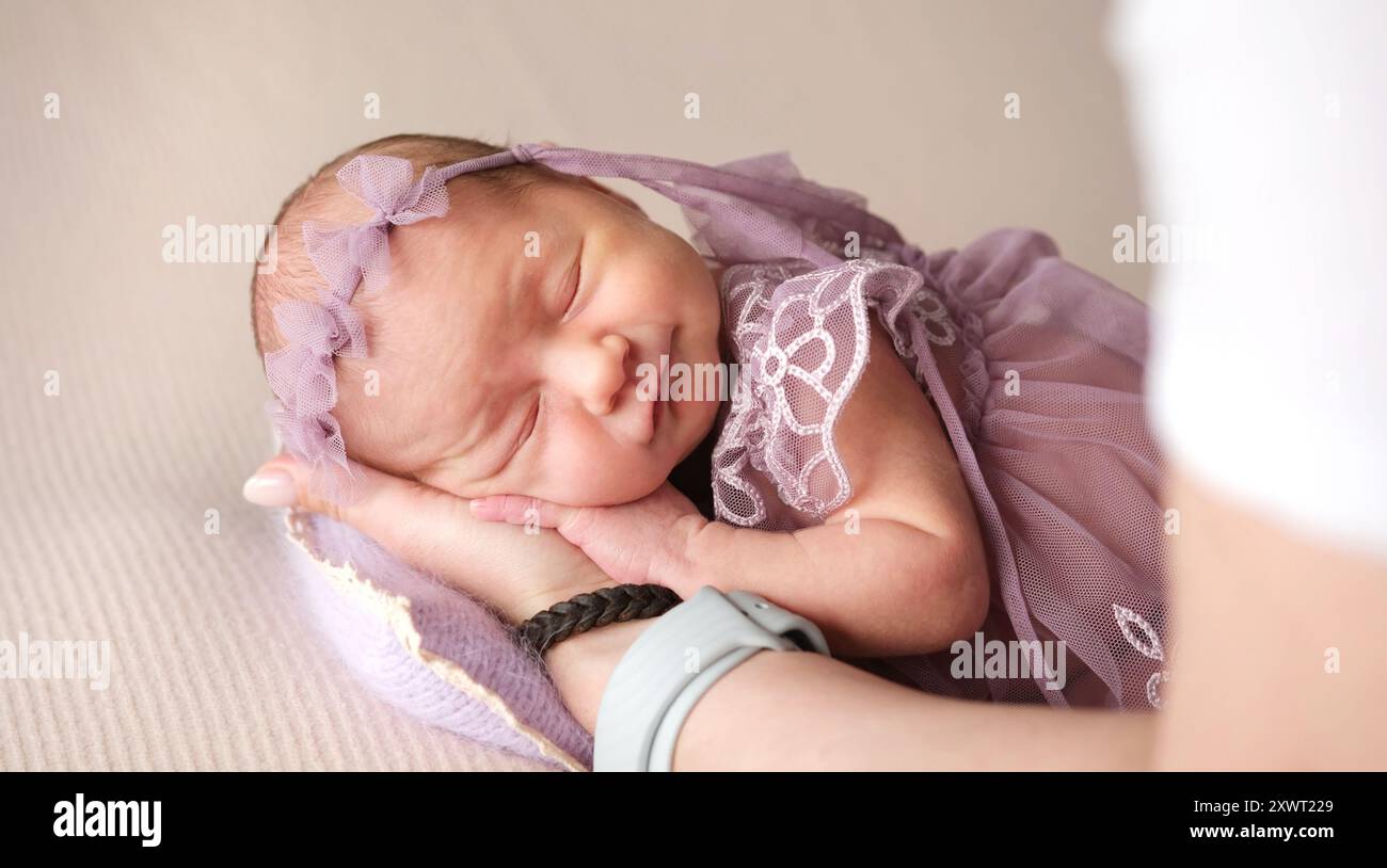 Mother cradling baby in arms hi-res stock photography and images - Alamy