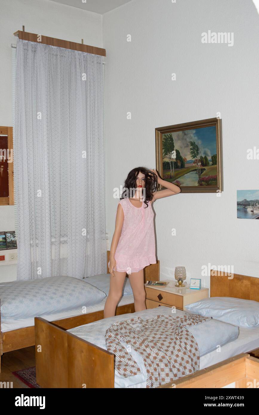A mannequin dressed in vintage nightwear stands in a retro-styled ...