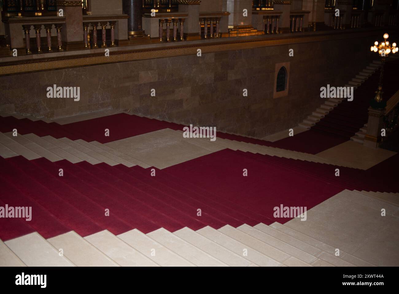 A grand staircase adorned with red carpet inside the Hungarian ...