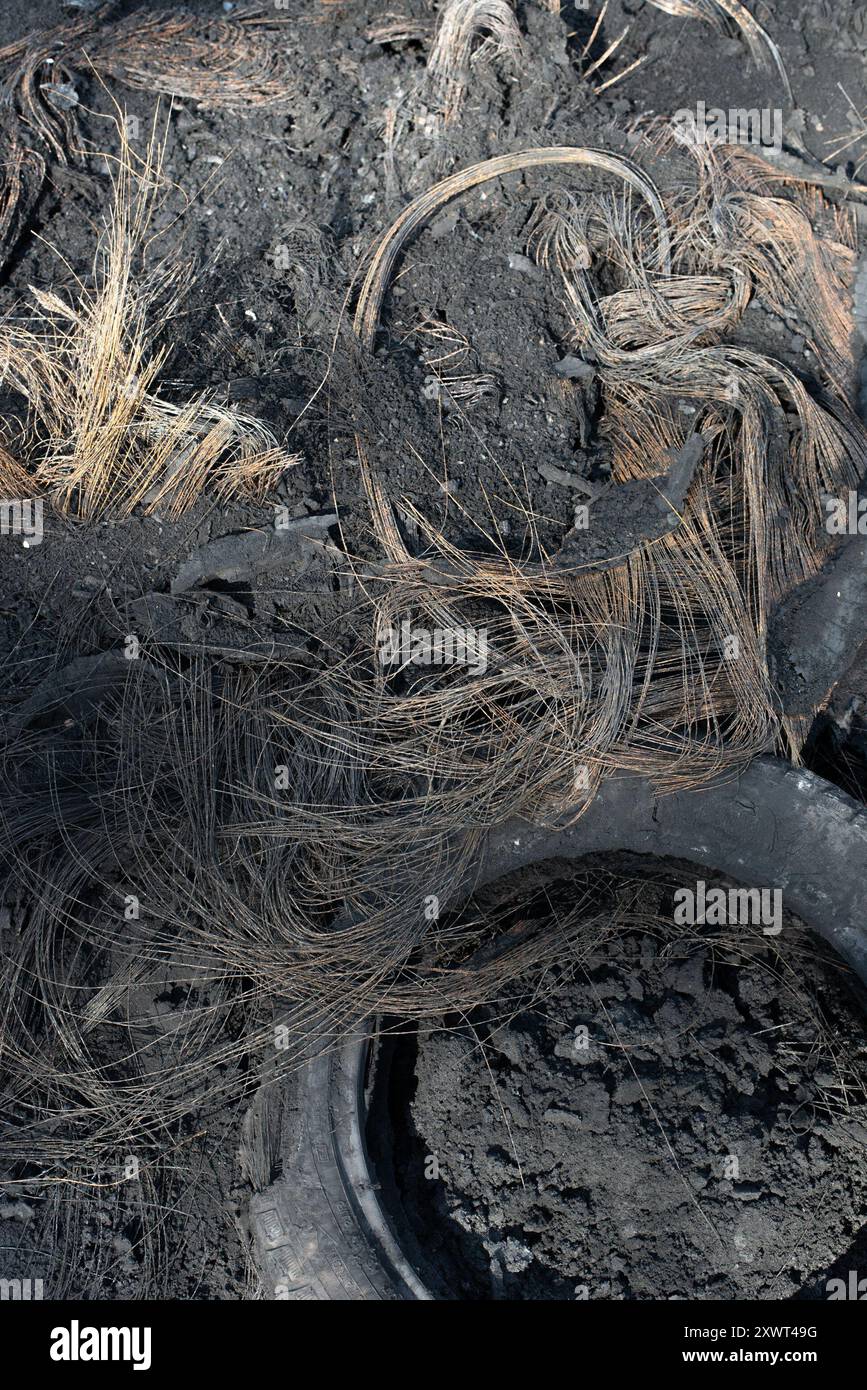 Close-up image of burnt tires showing exposed wires intertwined with ...