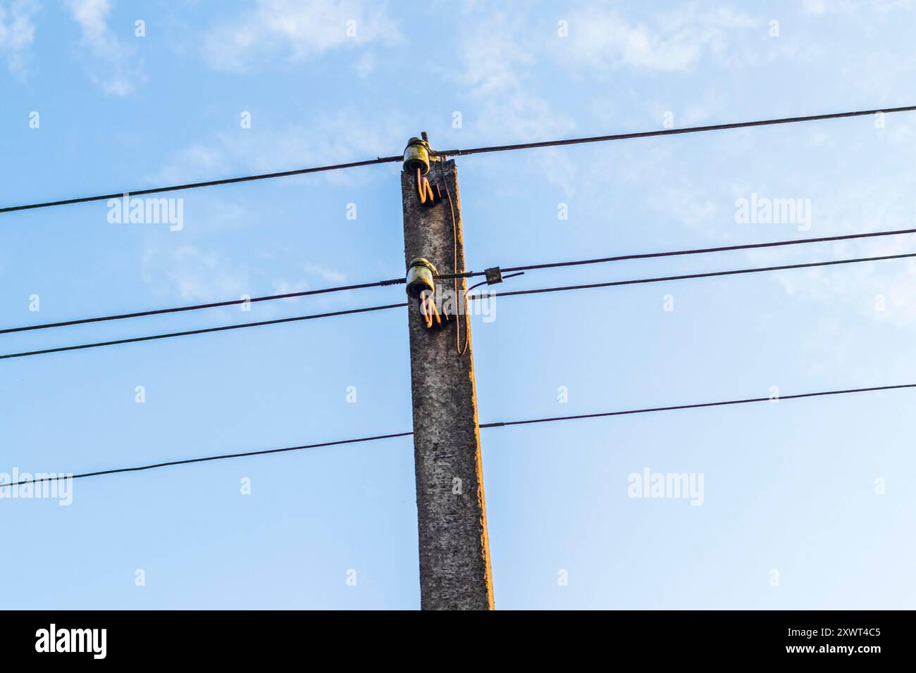 Shot of the old electrical wire posts in the village Stock Photo - Alamy