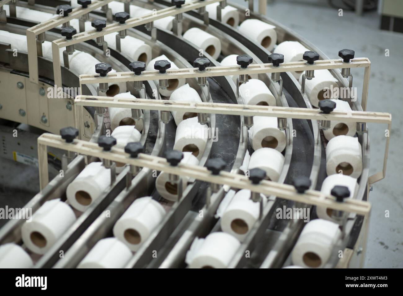 Close-up view of an automated production line manufacturing toilet ...