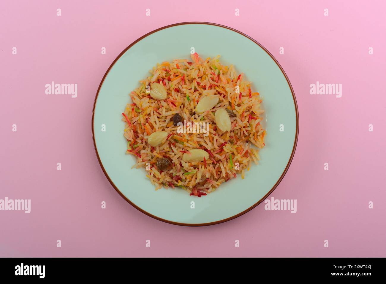 Colourful Asian Zarda rice on a white plate pink background Stock Photo ...
