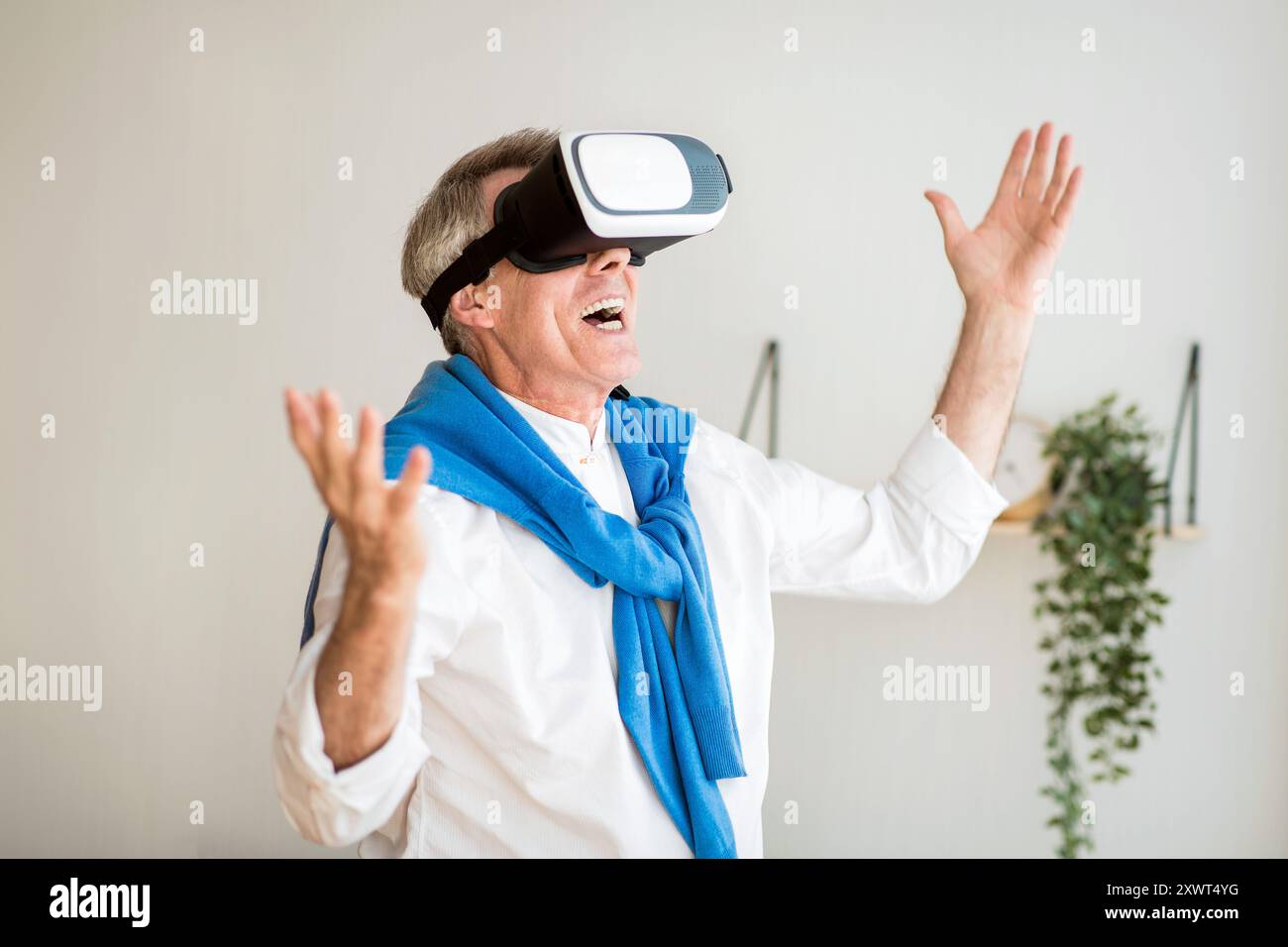 Augmented reality. Mature man with virtual headset Stock Photo - Alamy
