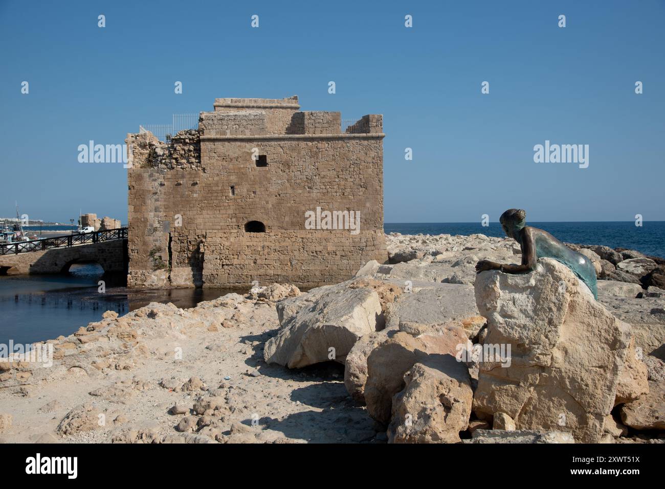 A bronze statue of woman called Sol Alter on a stone looking at the ...