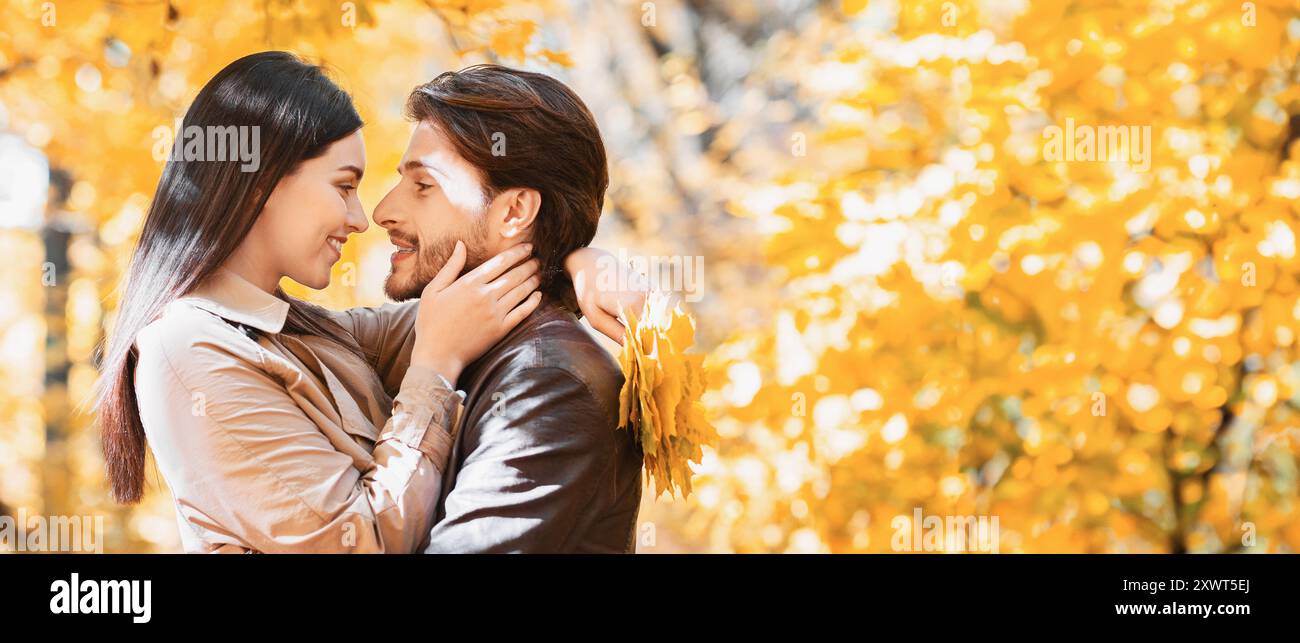 Loving girl touching her boyfriend face while cuddling in park Stock ...