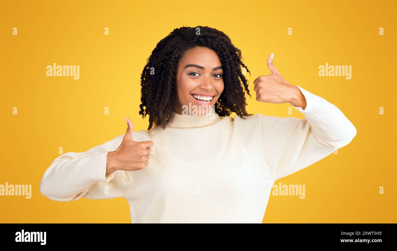 Smiling african american student showing thumbs up Stock Photo - Alamy