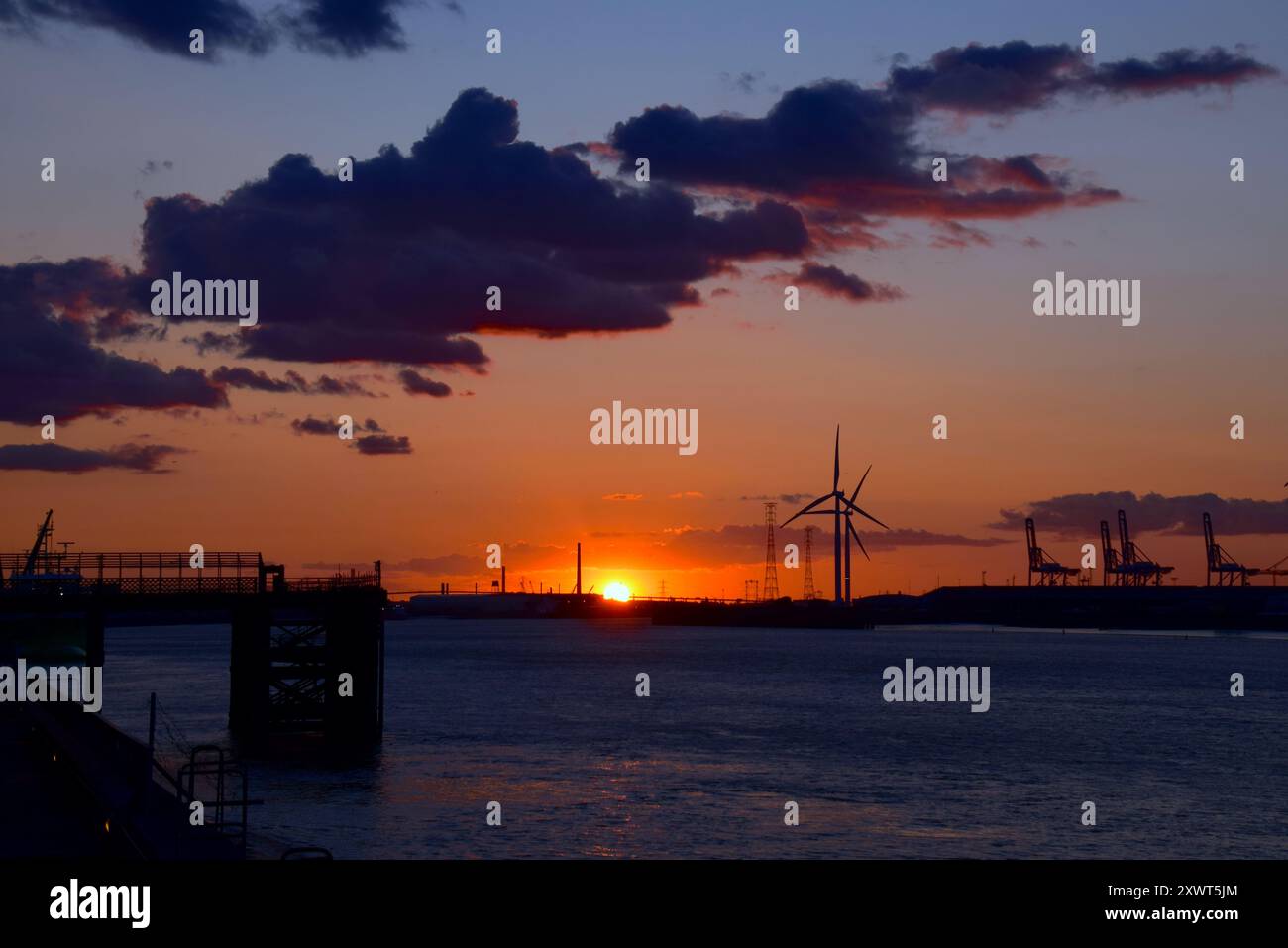 A sunset on the River Thames near Gravesend in Kent silhouettes the ...