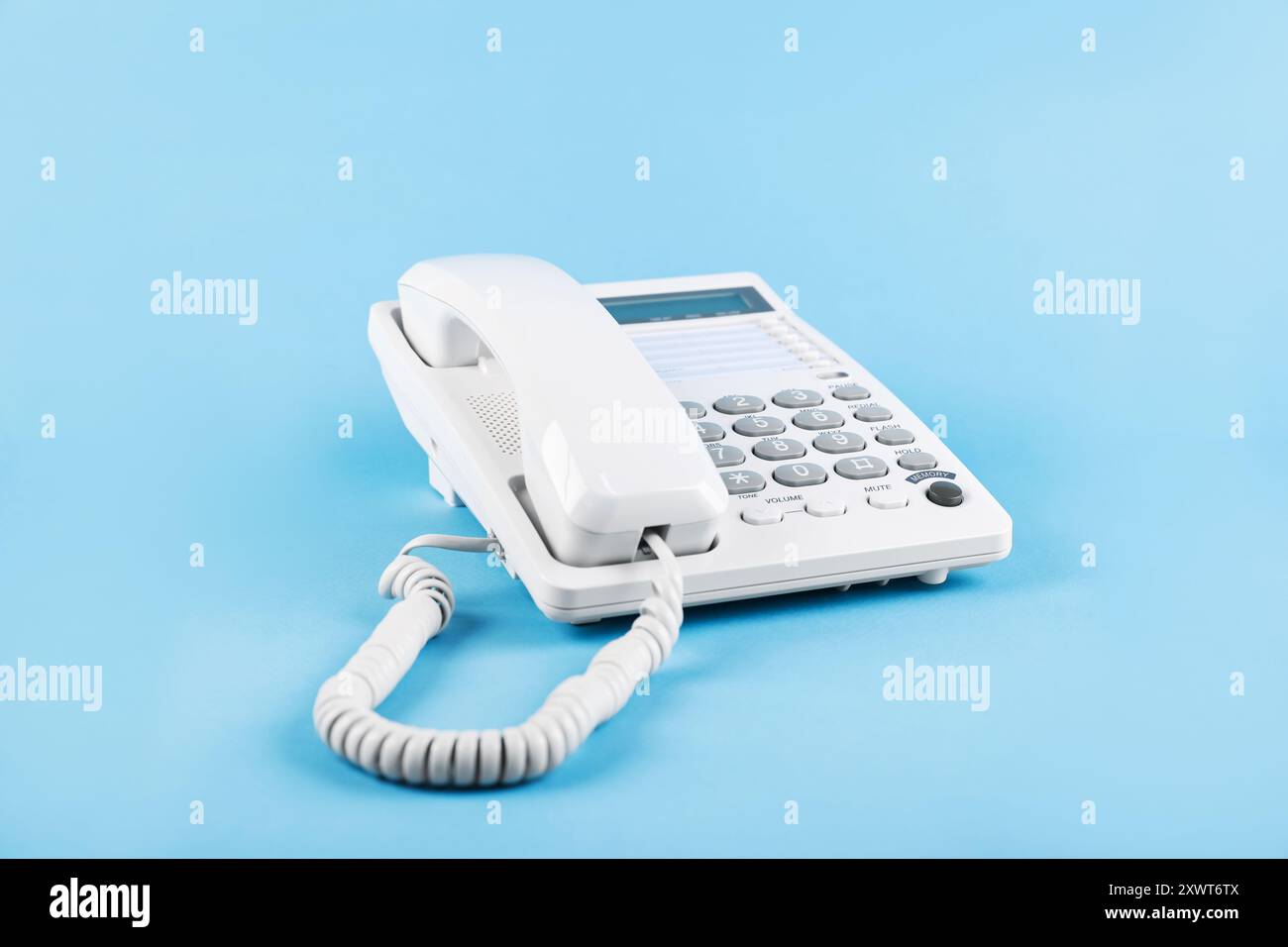 White telephone with handset on light blue background Stock Photo - Alamy