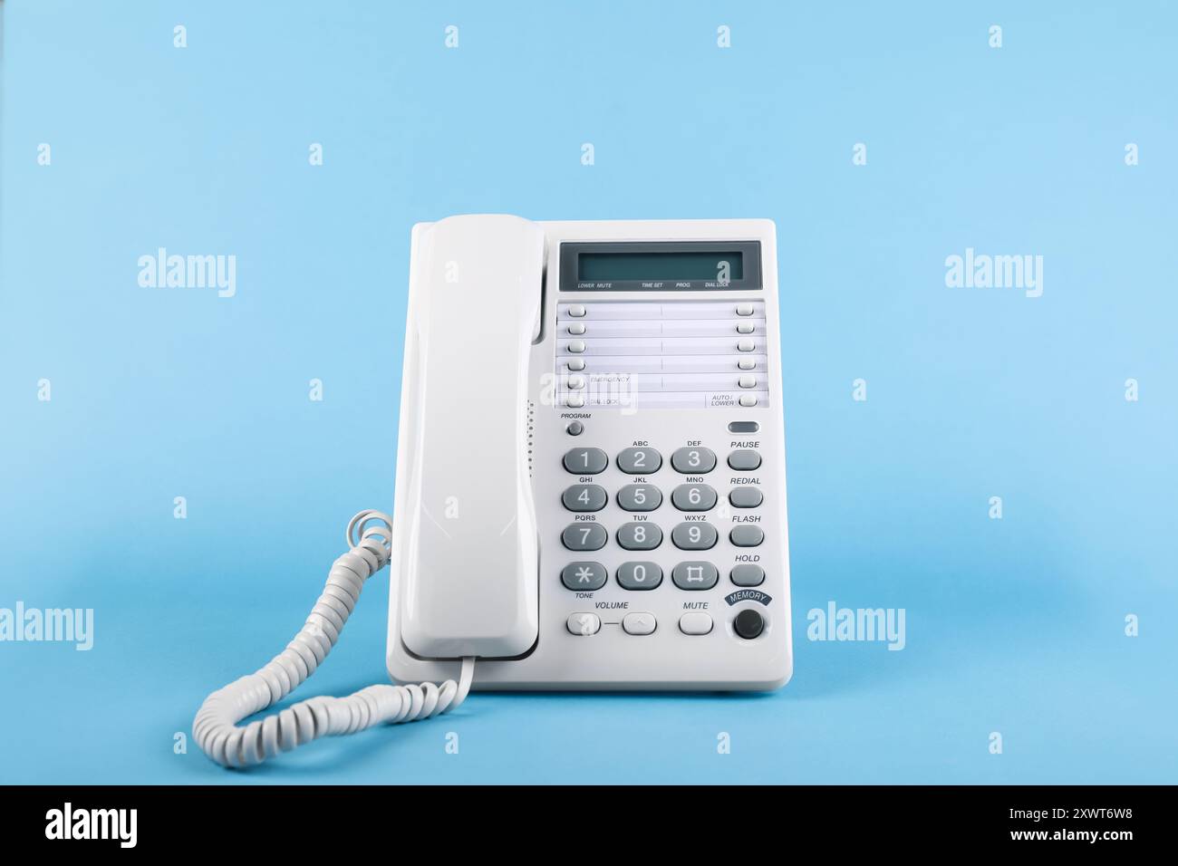 White telephone with handset on light blue background Stock Photo - Alamy