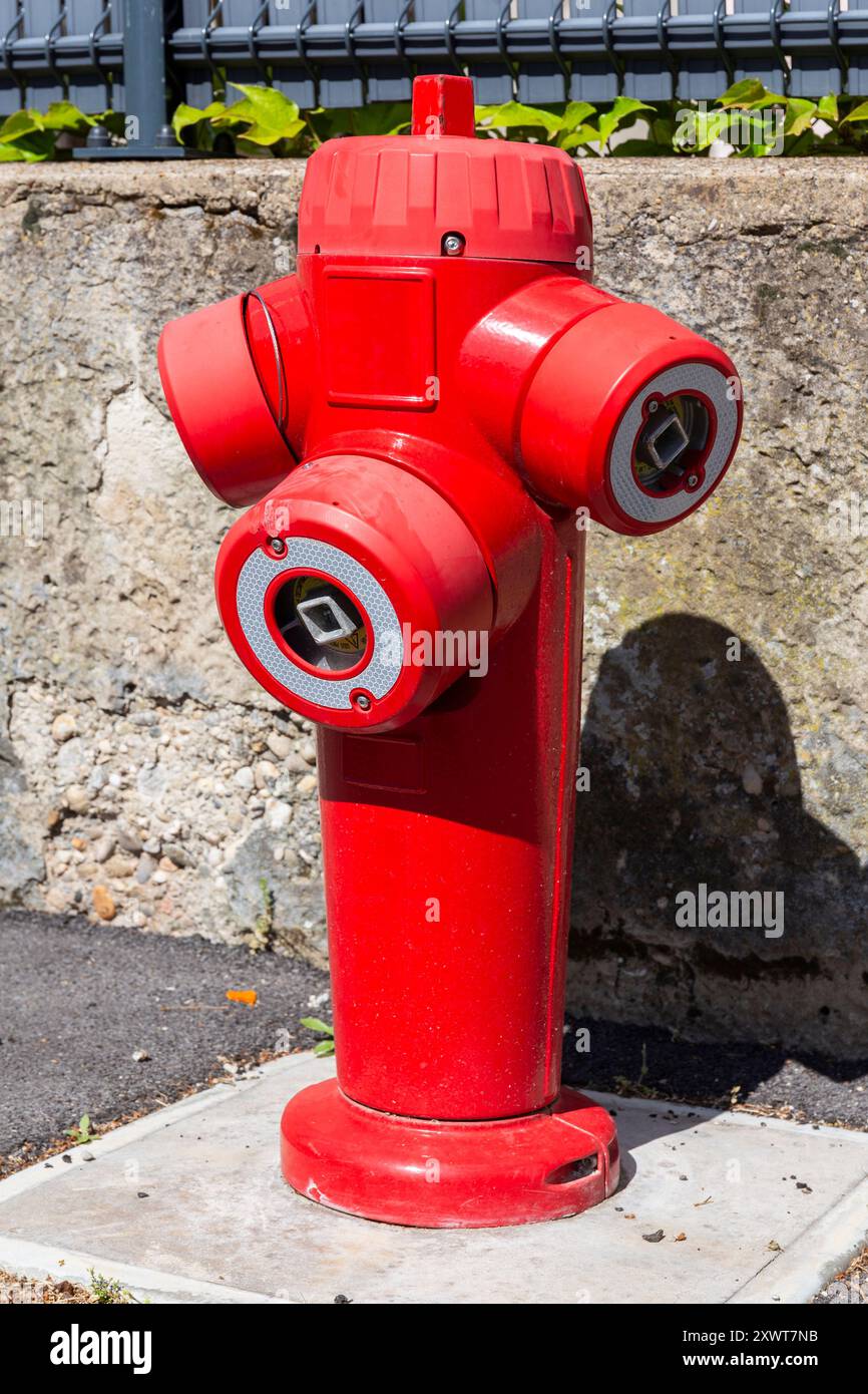 Fire hydrant in french street. Red triple fire hydrant on the street ...