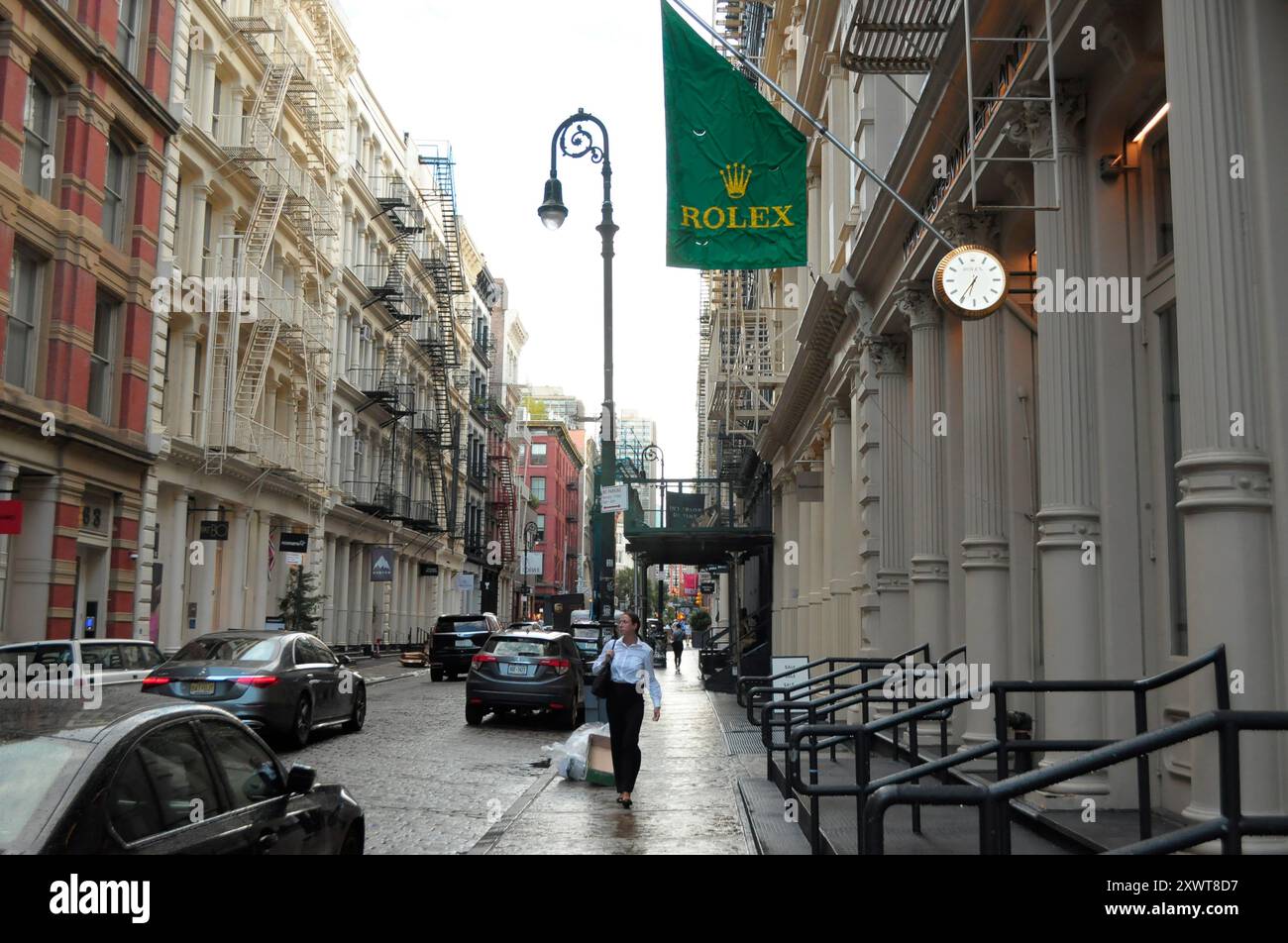 People are seen walking down the street in the SoHo neighborhood in ...