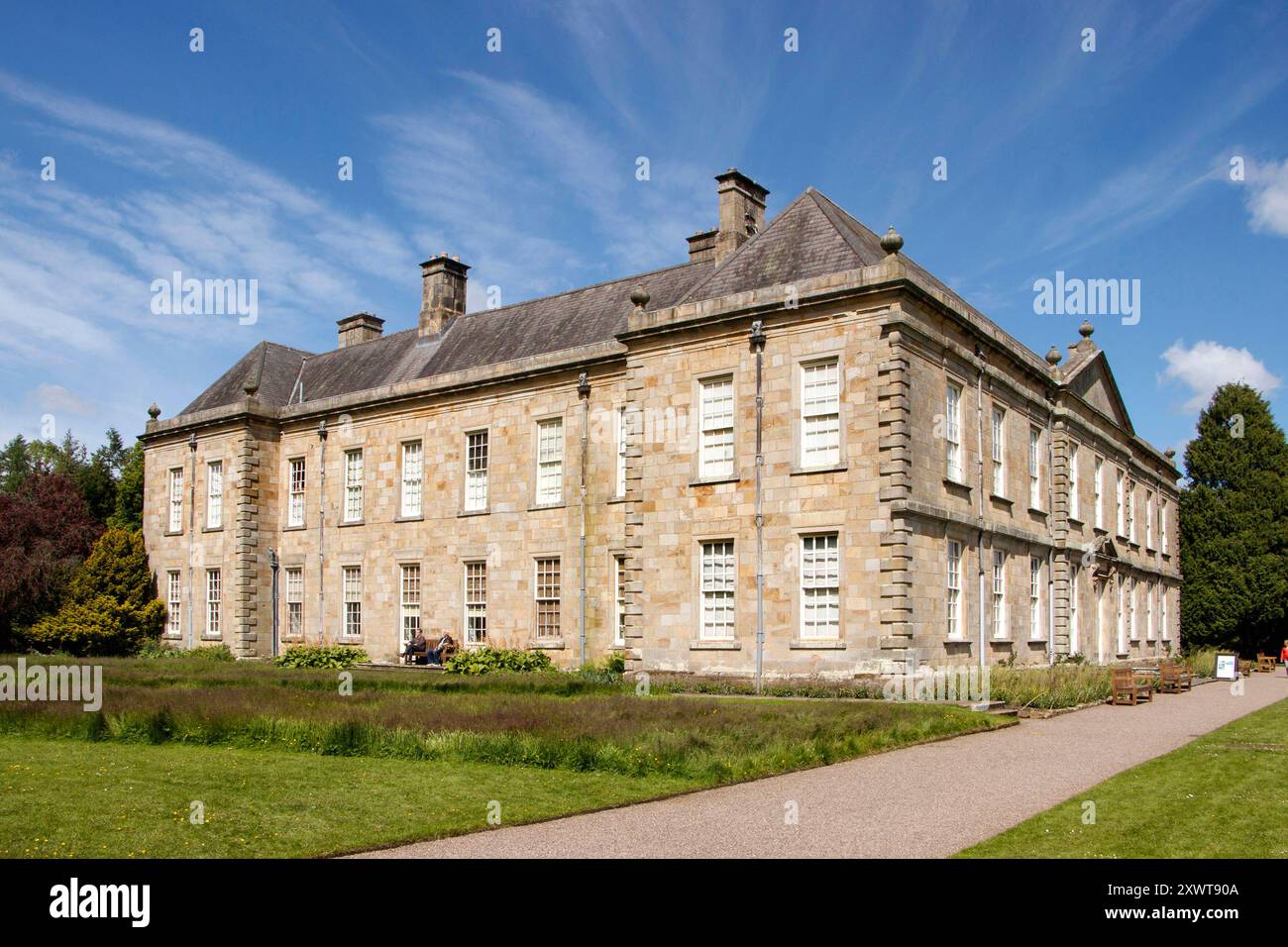 Historic stone mansion wallington hall with manicured gardens under a ...