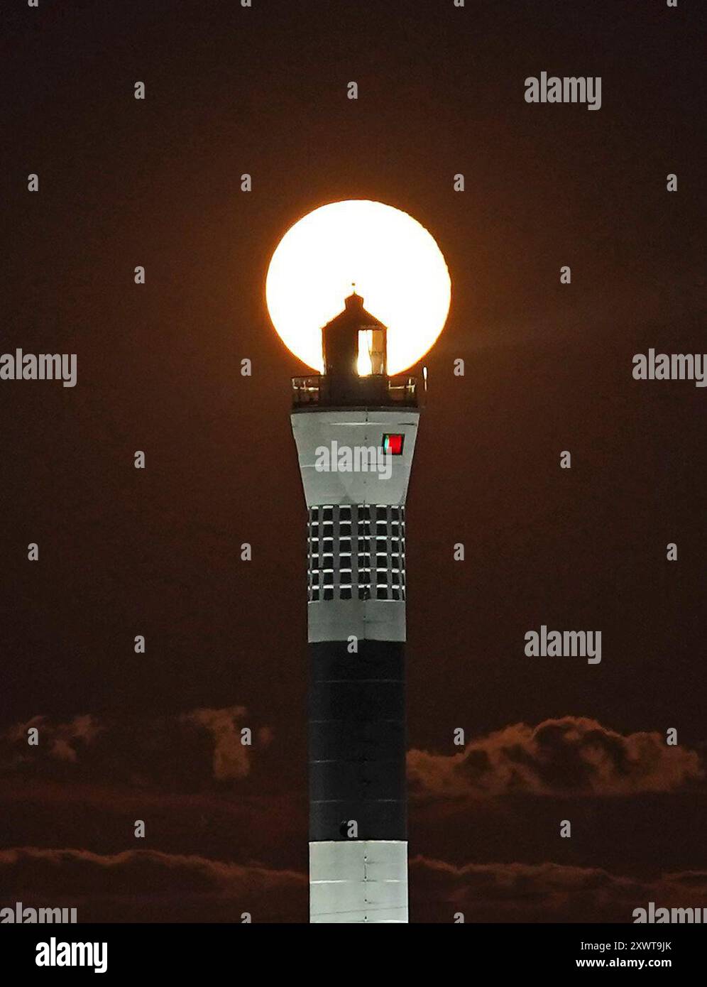 A supermoon is visible over the new Dungeness lighthouse in Kent. The ...