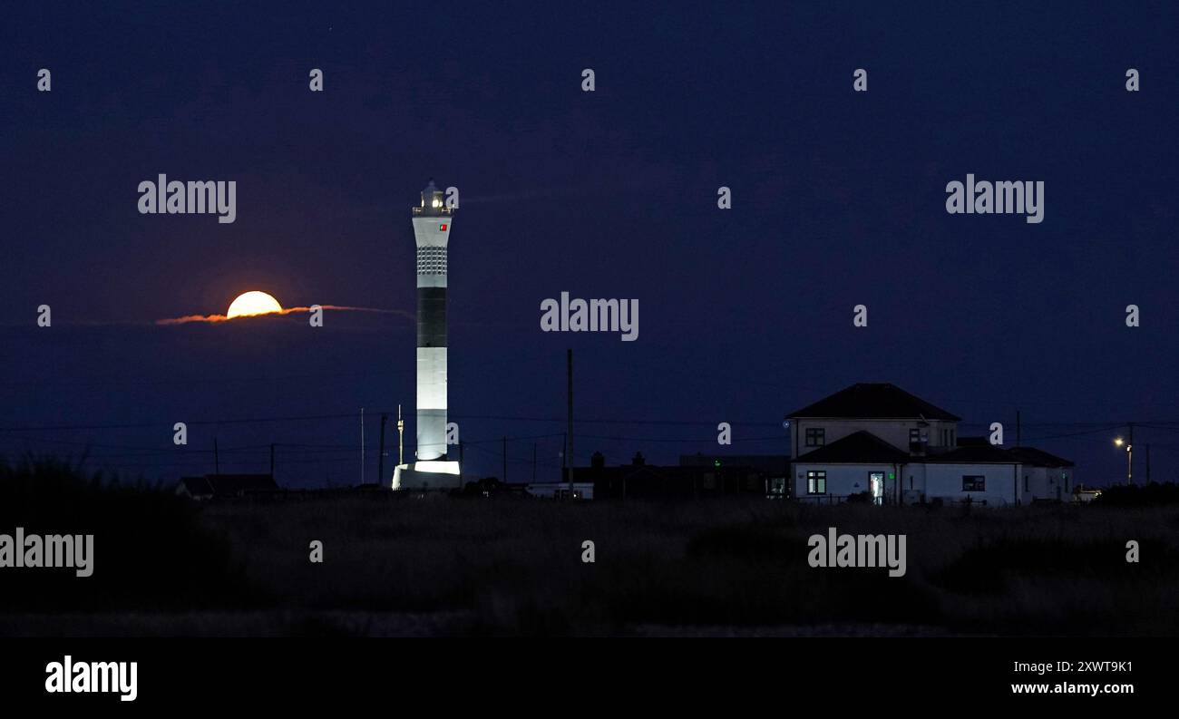 A supermoon is visible over the new Dungeness lighthouse in Kent. The ...