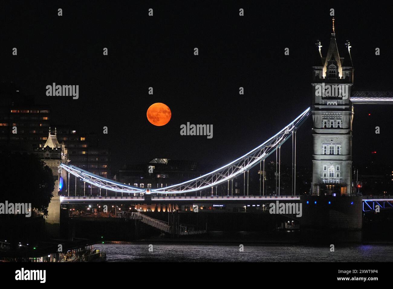 A waning gibbous moon rises over Tower Bridge in London. Picture date ...