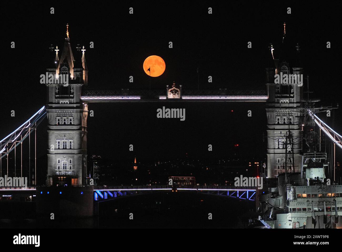 A waning gibbous moon rises over Tower Bridge in London. Picture date ...