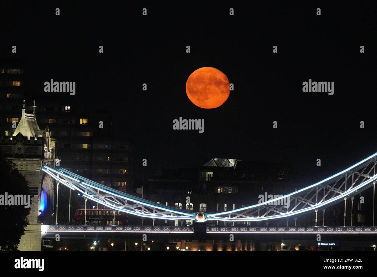 A waning gibbous moon rises over Tower Bridge in London. Picture date ...