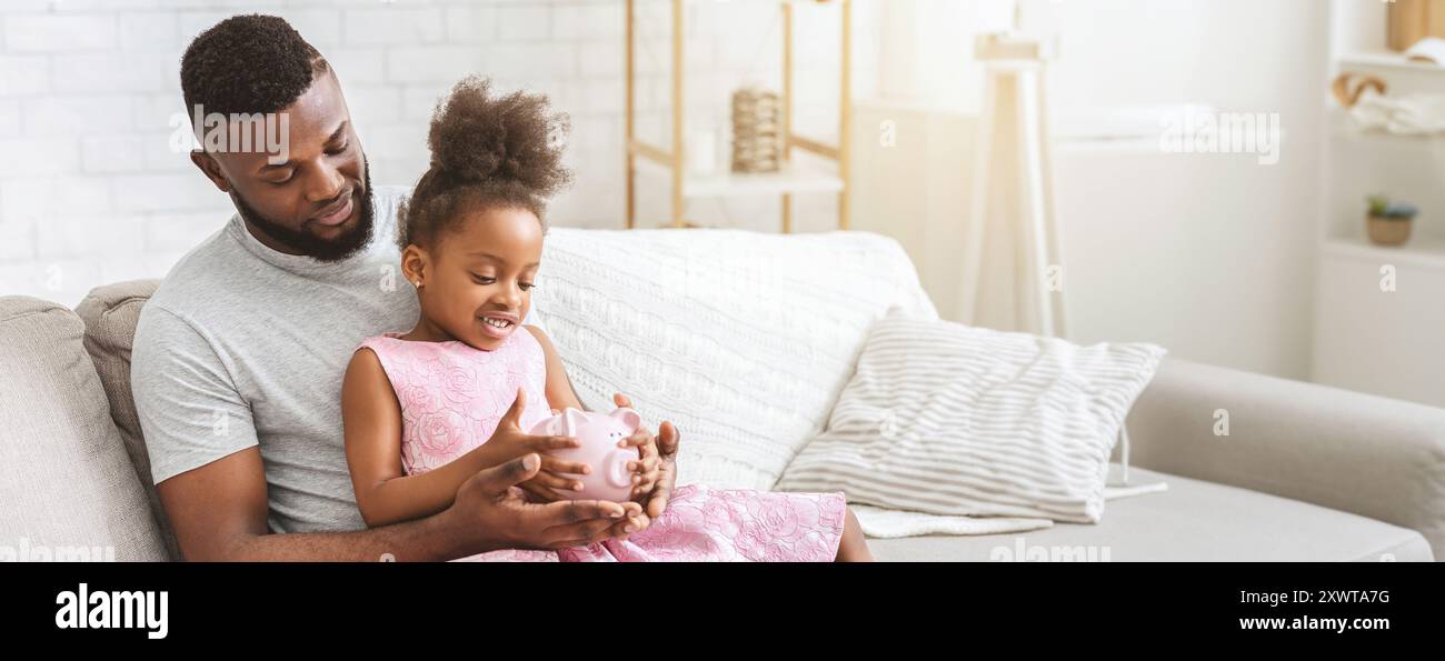 Father teaching daughter saving money hi-res stock photography and ...