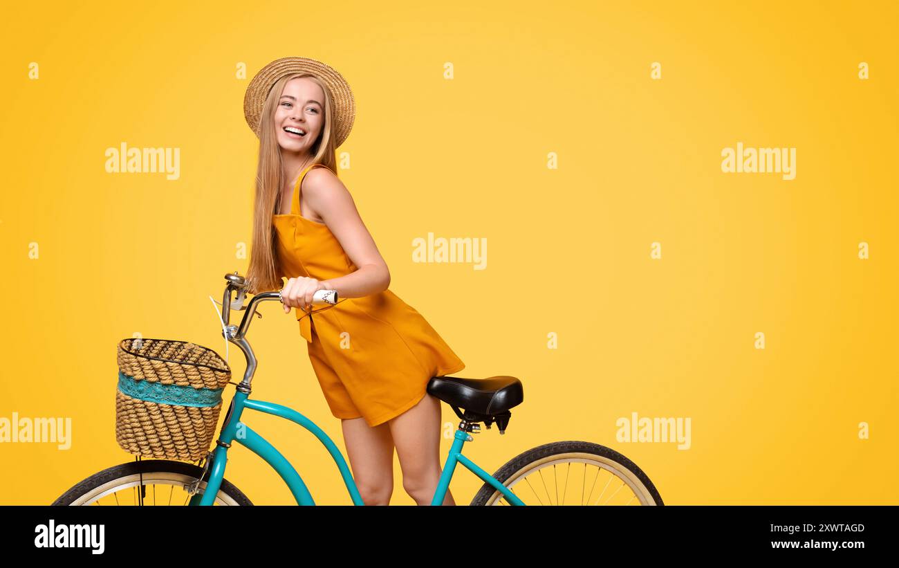 Beautiful young girl in summer clothes riding bike over yellow ...