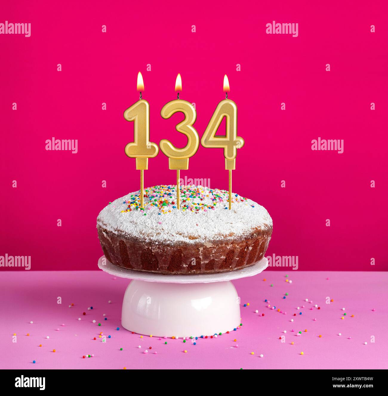 Lighted birthday candle number 134 - Birthday card on pink background ...