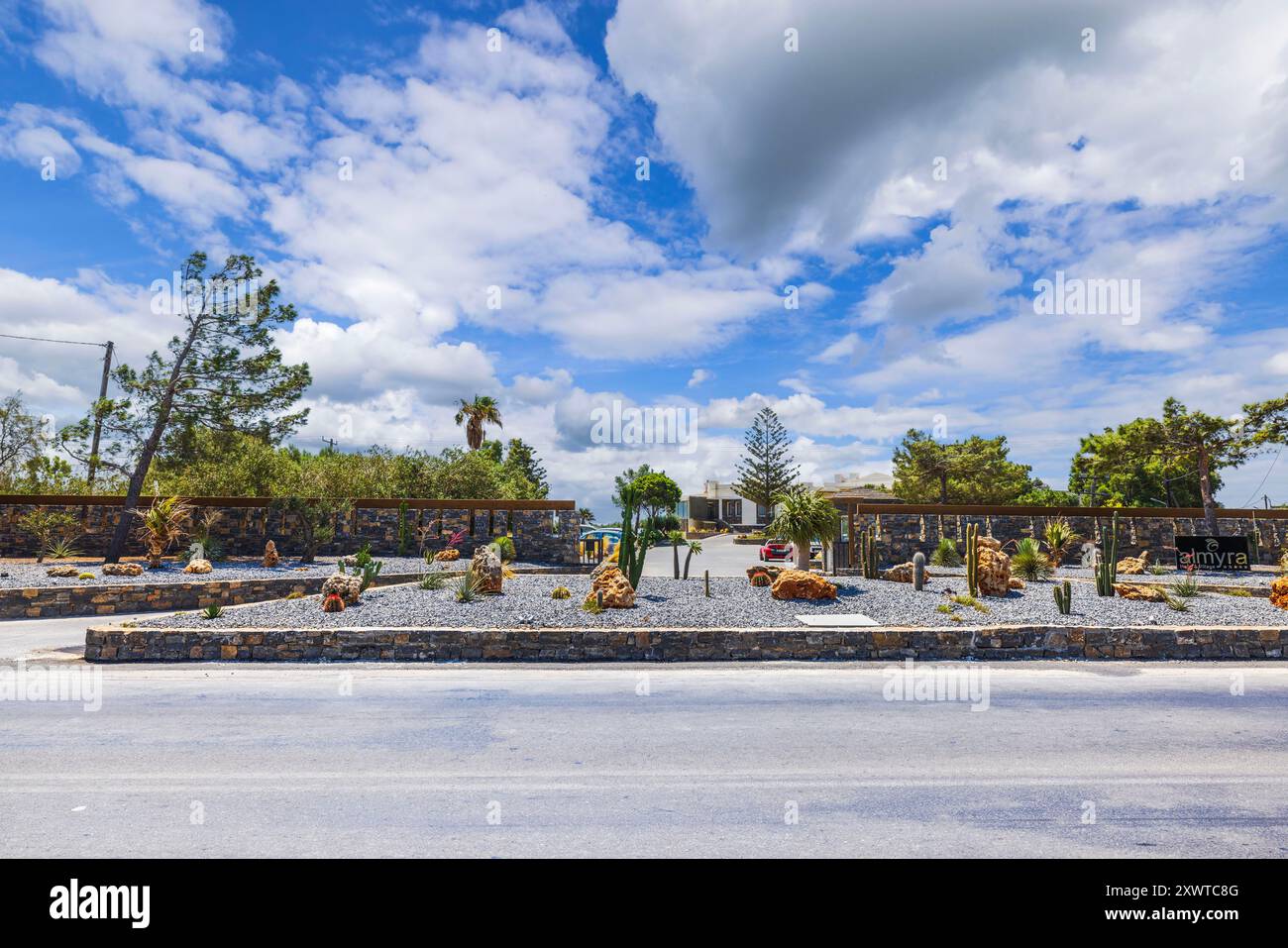 Beautiful landscape view of the driveway entrance to a Mediterranean ...