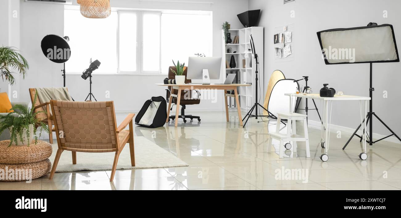 Interior of modern studio with photographer's workplace and equipment ...