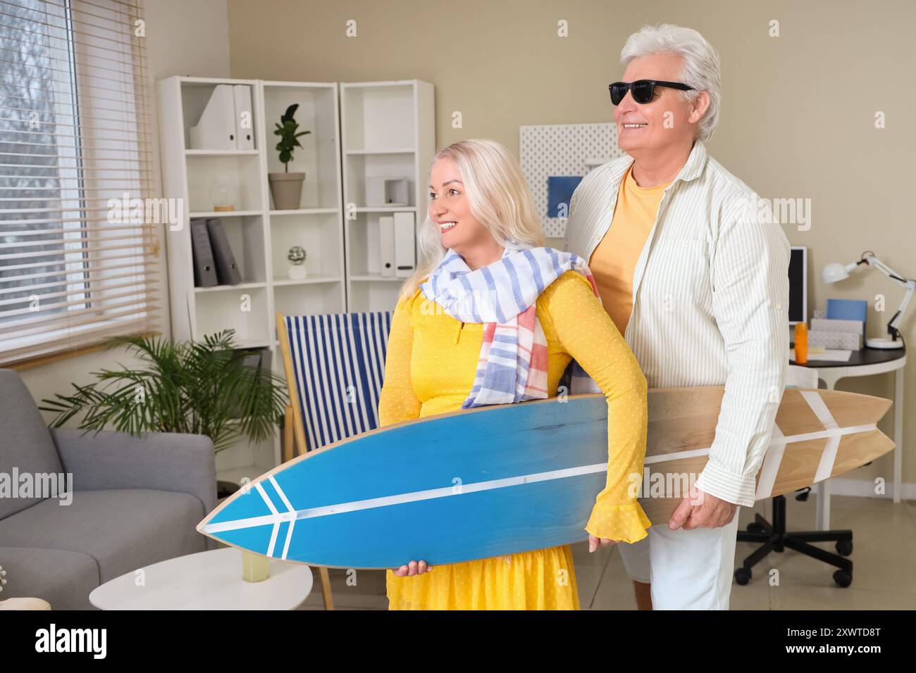 Mature business people with surfboard ready for summer vacation in ...