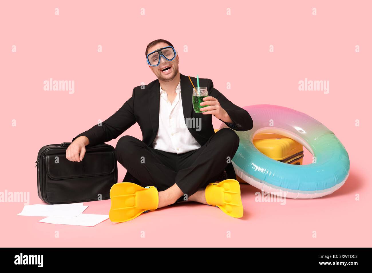 Happy office worker in diving mask with cocktail, briefcase and ...